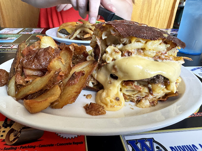 This isn't just a cheeseburger&mdash;it's an architectural marvel of melty cheese cascading down a tower of beef and toppings. Fork and knife recommended, napkins mandatory.