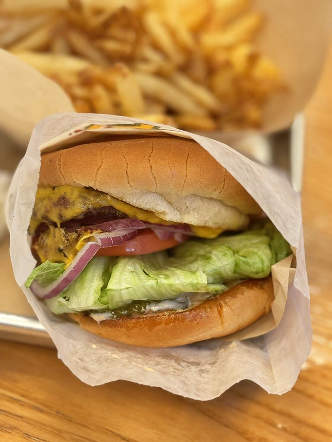 The classic cheeseburger—where melted American cheese meets char-broiled patty in a romance that's lasted longer than most Hollywood marriages.