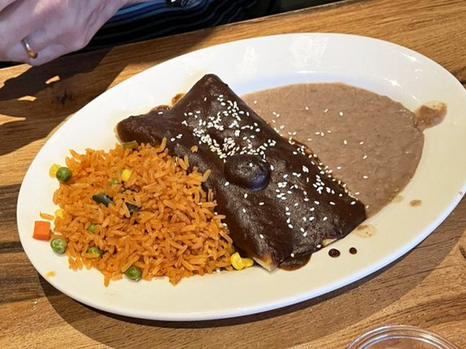 The chicken mol&eacute; enchilada wears its complex sauce like royalty wears a robe&mdash;with dignity, richness, and a hint of mystery.