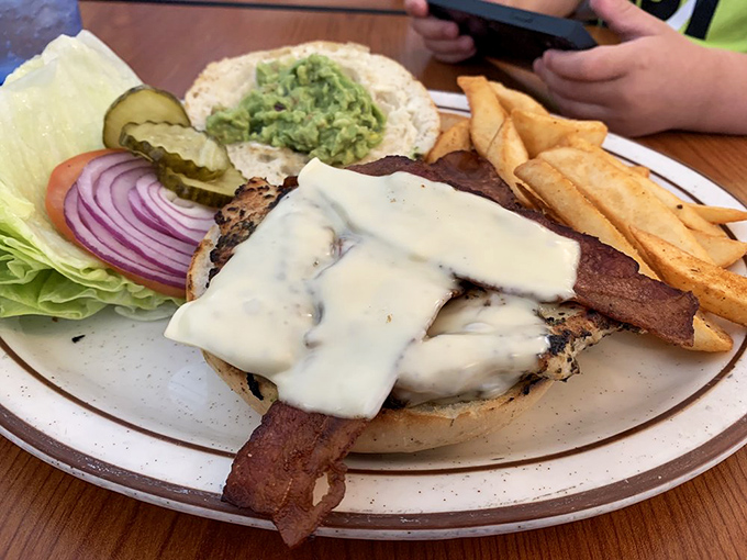 This isn't just a chicken sandwich &ndash; it's architecture with avocado, where melty cheese cascades over perfectly grilled chicken like a dairy waterfall.