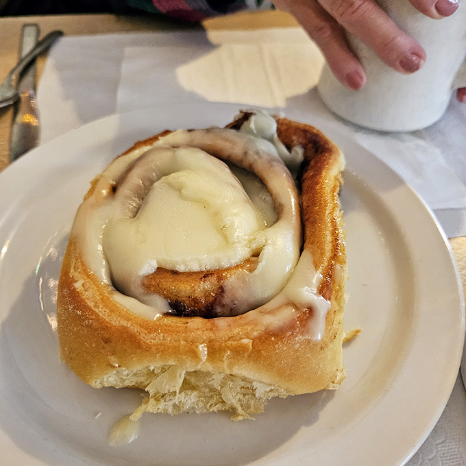 This cinnamon roll isn't just breakfast &ndash; it's dessert masquerading as a morning meal, with icing melting into every warm, spiraled crevice.