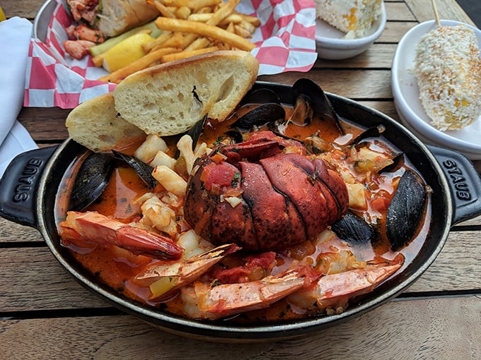 A cast-iron skillet of seafood symphony&mdash;lobster tail conducting an orchestra of shrimp, mussels, and potatoes in a tomato-based broth.