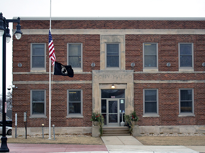 Worthington's City Hall balances historic charm with civic purpose, its brick fa&ccedil;ade and American flag embodying small-town governance at its best.