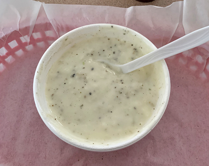 Clam chowder so creamy and flavorful it could make a New Englander question their loyalty. Speckled with herbs and generous with clams.