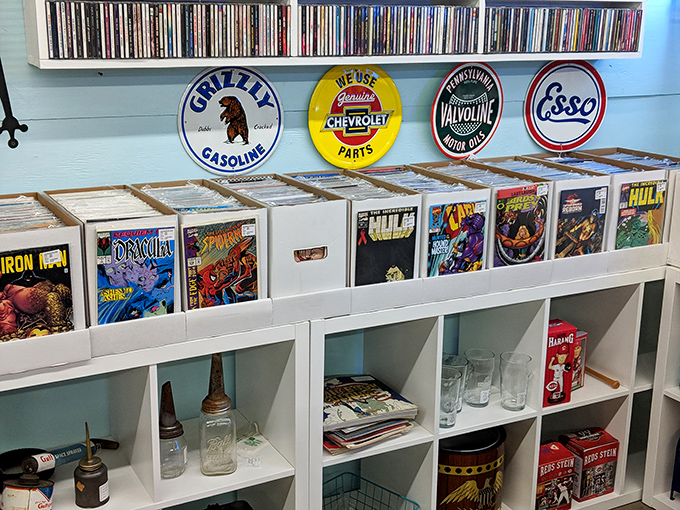 Comic books and vintage signs create a nostalgic gallery where Spider-Man meets Esso and everyone's happy.