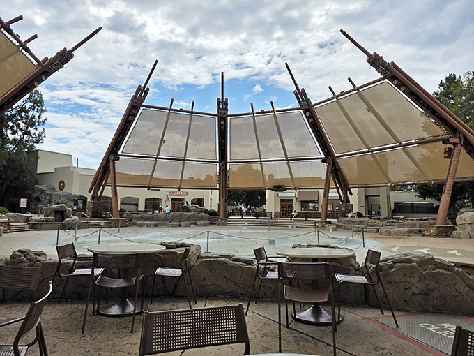 The center's distinctive architectural canopies create an outdoor oasis that says, "This isn't your average strip mall, darling." Desert-inspired design meets shopping sanctuary.