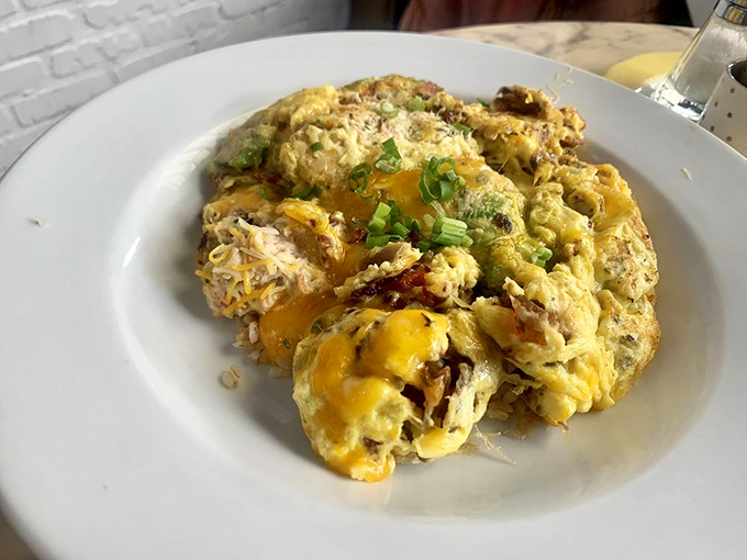Comfort food elevated to art form. Melted cheese cascades over what appears to be a hearty egg dish&mdash;proof that breakfast knows no boundaries here.