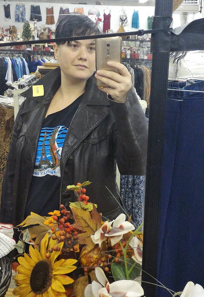 The mirror section: where vintage leather jackets find new owners amid seasonal decorations. Every reflection shows a potential new you.