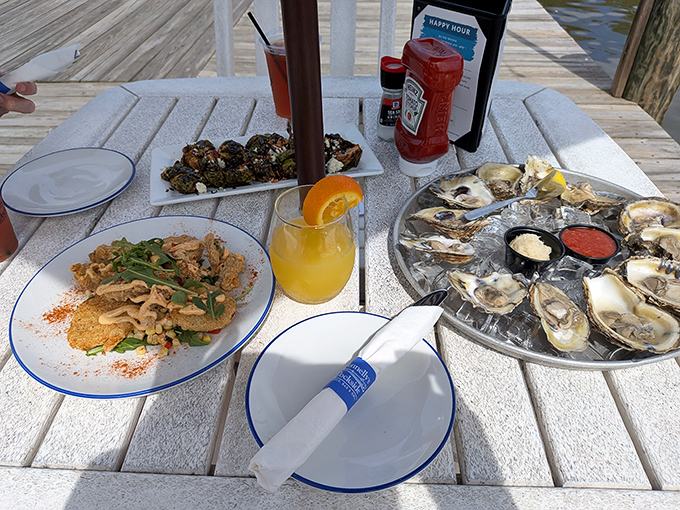 Waterside dining with oysters and fried deliciousness spread across the table like an edible treasure map of happiness.