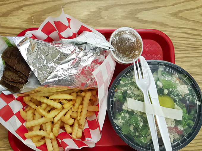 Simple pleasures: a classic sandwich, golden fries, and a fresh salad on a red tray&mdash;the holy trinity of lunch done right.