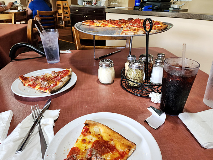 The classic pizza parlor experience lives on. That elevated pie stand, the table condiments, the soda in proper glasses&mdash;some traditions are worth preserving.