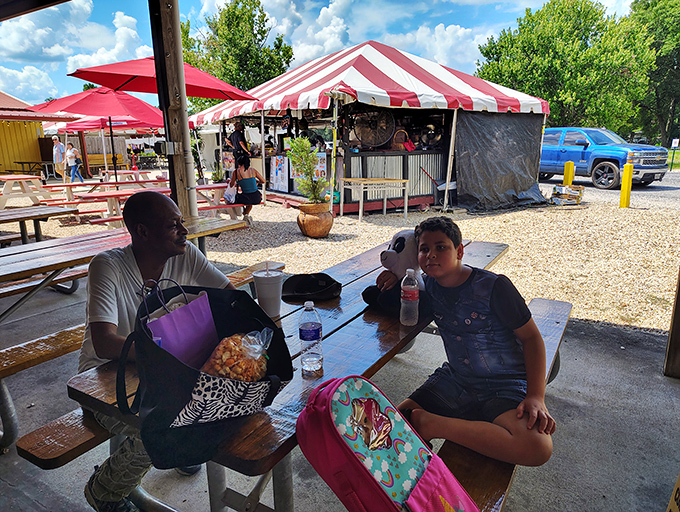 The universal language of flea market dining: simple tables, good company, and the satisfaction of resting your feet after scoring the perfect find.