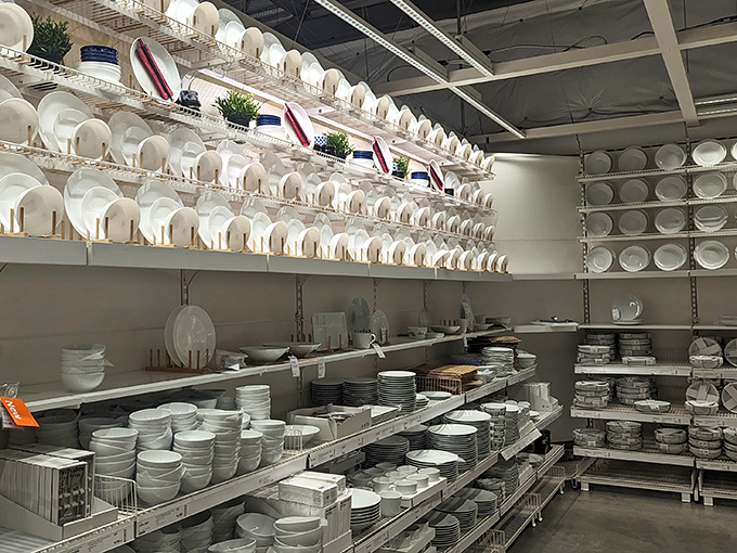 The white plate wall at HomeGoods&mdash;where dinner party dreams are born and credit cards go to die, one perfectly affordable serving dish at a time.