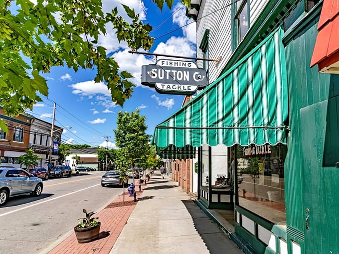 Another angle on Main Street reveals Sutton Co.'s iconic green awning, standing sentinel over sidewalks that have witnessed generations of small-town conversations.