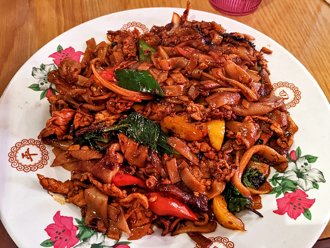 Drunken noodles living up to their name with wide ribbons of pasta tangled with vegetables and that signature Thai basil.