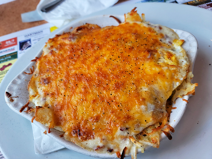 This cheese-crowned masterpiece isn't just breakfast—it's edible architecture, with layers of flavor that would make Frank Lloyd Wright put down his blueprints and pick up a fork.