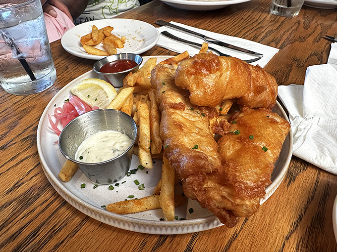 Fish and chips that would make a British pub regular weep with joy&mdash;golden-battered perfection alongside fries that demand to be savored.