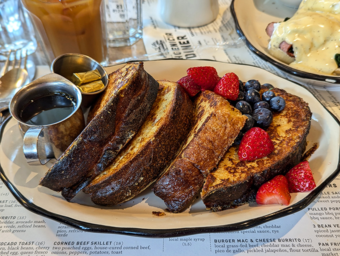 French toast that's lived its best life, golden-brown and surrounded by berries like a breakfast celebrity with a colorful entourage.