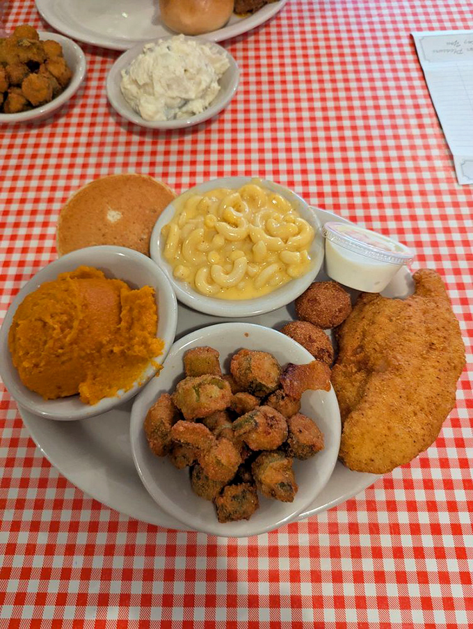 Southern hospitality on a plate: golden-fried catfish, crispy okra, and sweet potato casserole that could make a vegetable skeptic reconsider their position.