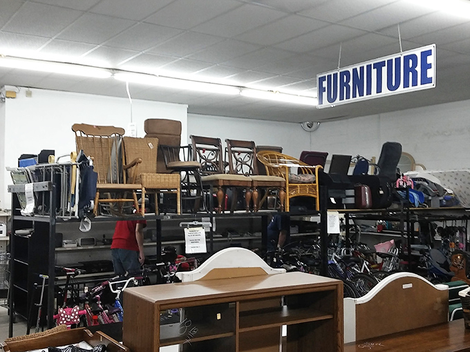 The "FURNITURE" sign might as well read "Time Machine"&mdash;these wooden chairs and headboards have stories older than most Florida developments.