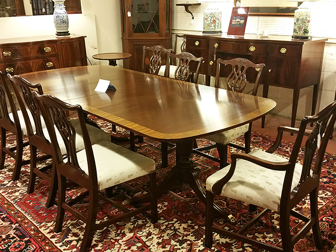 Elegant dining sets await their forever homes. This mahogany beauty silently judges your current IKEA ensemble from across the showroom.