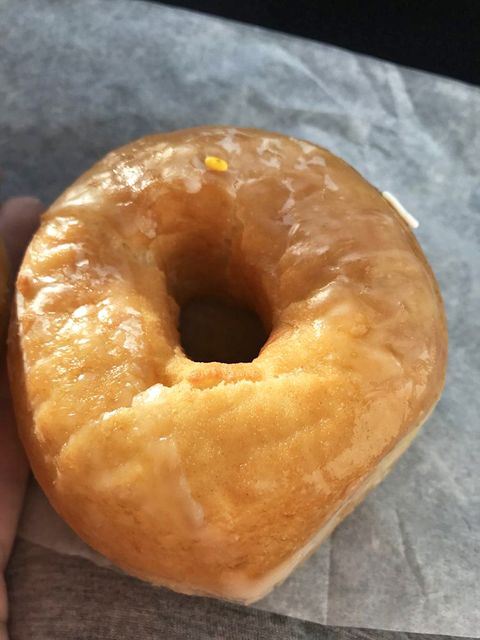The classic glazed donut, simple yet sublime, proving that sometimes perfection needs no embellishment or fancy toppings.
