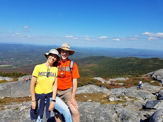 Summit selfies: the true peak experience. Nothing says "we conquered a mountain" like matching hats and triumphant smiles.