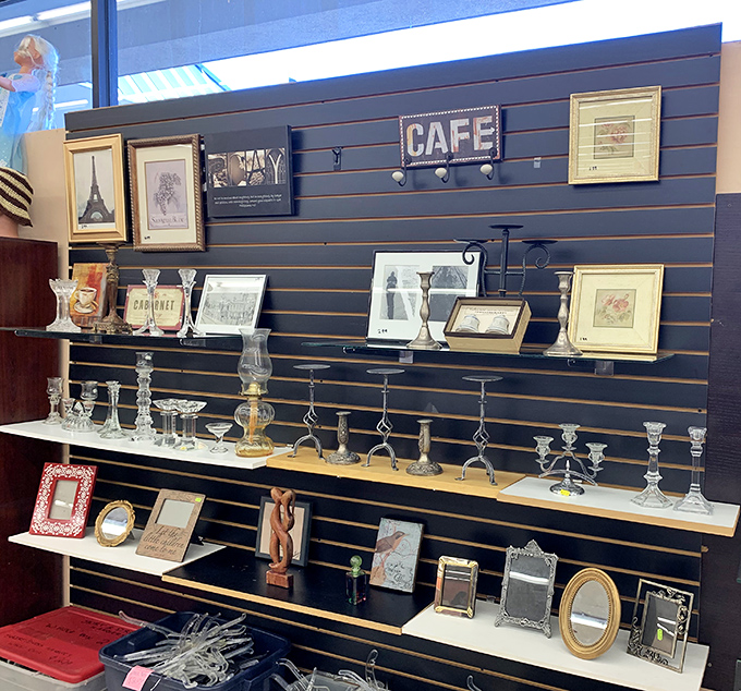 A wall of memories disguised as home d&eacute;cor&mdash;each frame and candle holder comes with its own mysterious backstory.