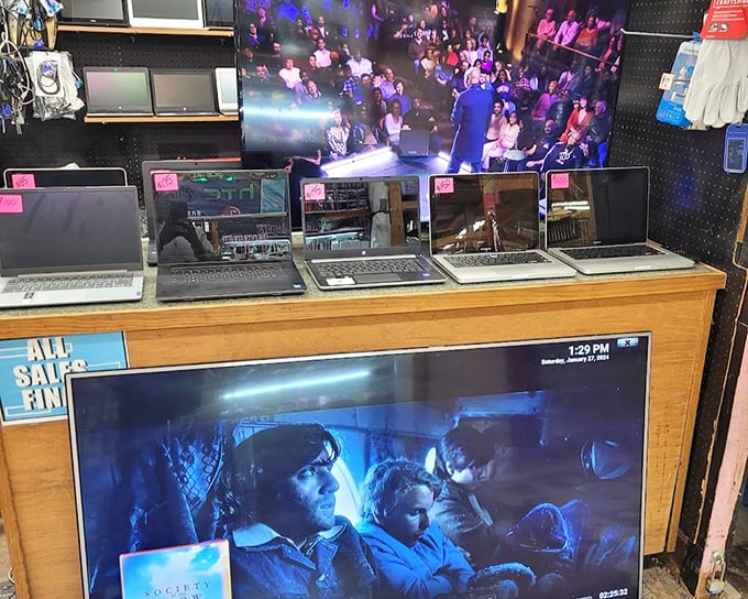 The laptop graveyard, where yesterday's technology awaits resurrection. That Windows 7 machine might just be someone's perfect first computer or vintage tech collection starter.