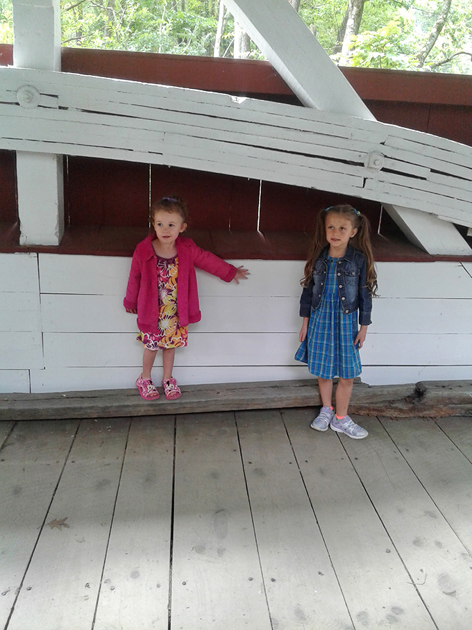 Young visitors pause inside, momentarily distracted from their tablets by actual, touchable history. Small miracles do happen.