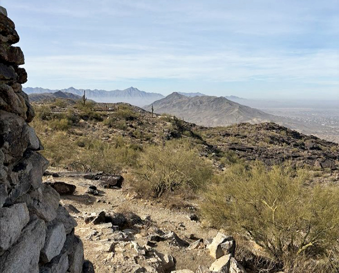 Desert poetry written in rock and sky. The rugged terrain of South Mountain creates a dramatic foreground to Phoenix's distant urban sprawl.