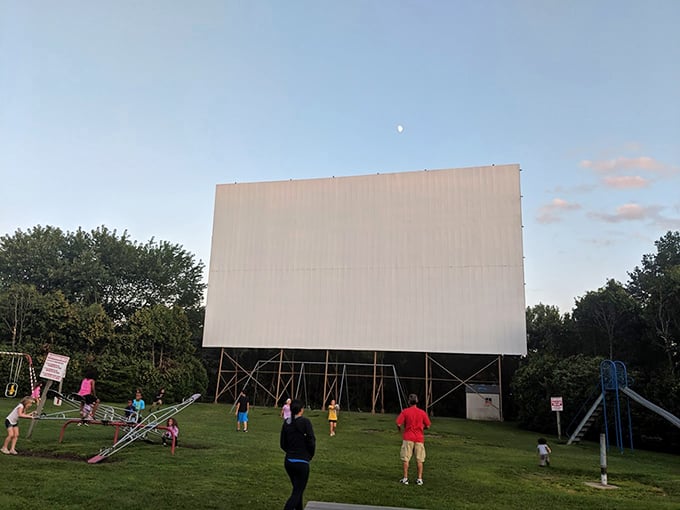 As dusk settles, this towering white canvas awaits its transformation into a 50-foot window to other worlds, framed by Ohio's twilight sky.