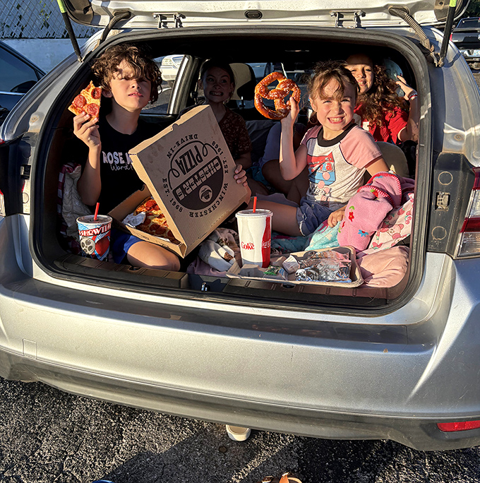 Family movie night elevated—pizza, pretzels, and the kind of trunk-based fort building that creates childhood memories that last decades.