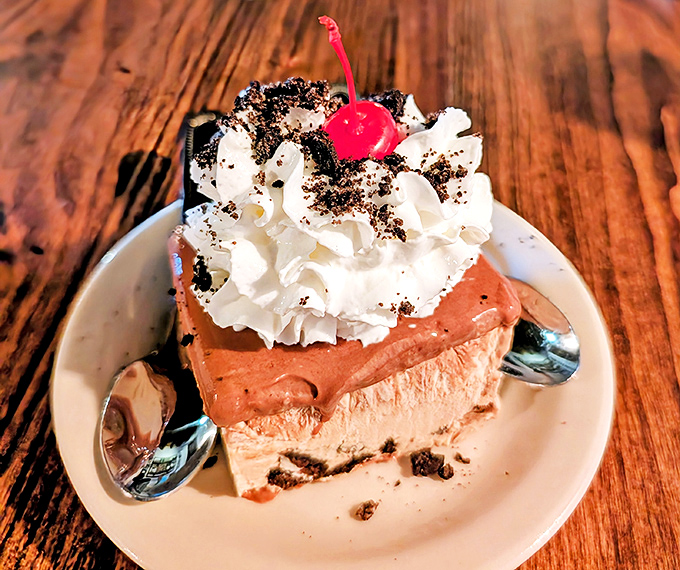 This isn't just dessert&mdash;it's architecture. Layers of chocolate mousse and cream topped with a cherry that's clearly living its best life.