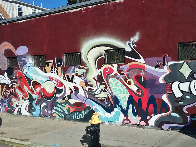 The exterior murals transform an ordinary building into an Allston landmark. Street art and vintage culture collide in spectacular fashion.