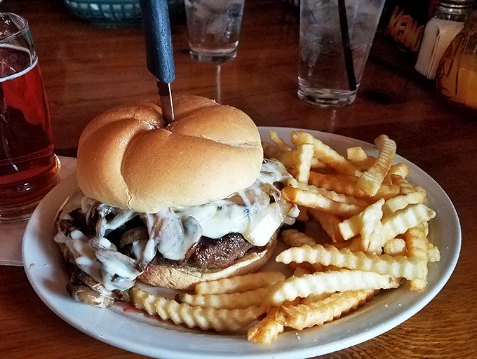 A burger that requires both hands and a strategy. The mushrooms and melted cheese create that umami explosion that makes your brain's pleasure center do a happy dance.