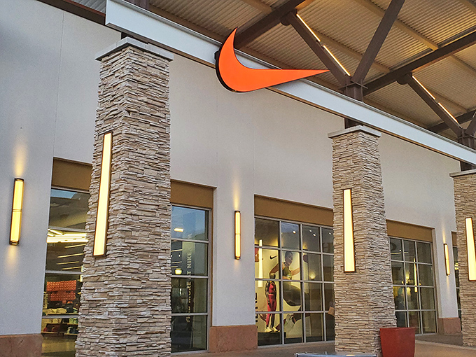 Nike's swoosh beckons shoppers like a siren song, with stone columns and dramatic lighting elevating the humble sneaker to art form.