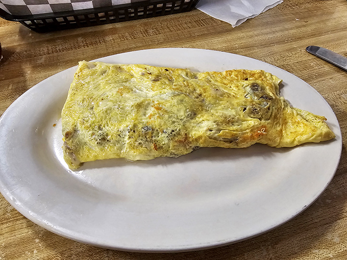 This omelet could feed a small nation, folded with the precision of origami but with considerably more cheese and deliciousness inside.