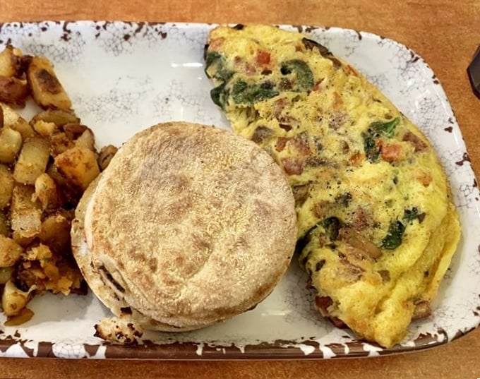 This omelet doesn't just sit on the plate&mdash;it commands attention with its perfect fold, melted cheese crown, and side of crispy potatoes.