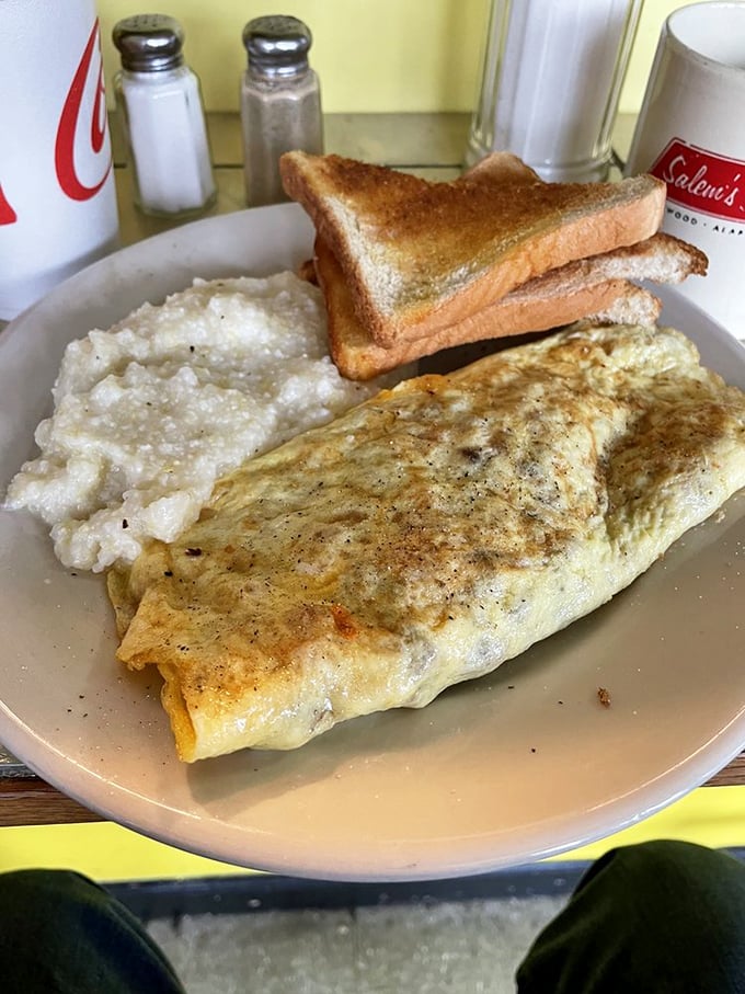 An omelet that knows its purpose in life: to be fluffy, generous, and paired with grits so creamy they could make a Frenchman reconsider his allegiance to bechamel.