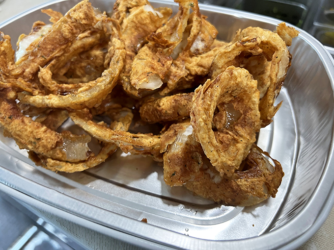 These onion rings aren't just side dishes &ndash; they're golden halos of happiness. The perfect crunch that makes you close your eyes and forget your troubles.