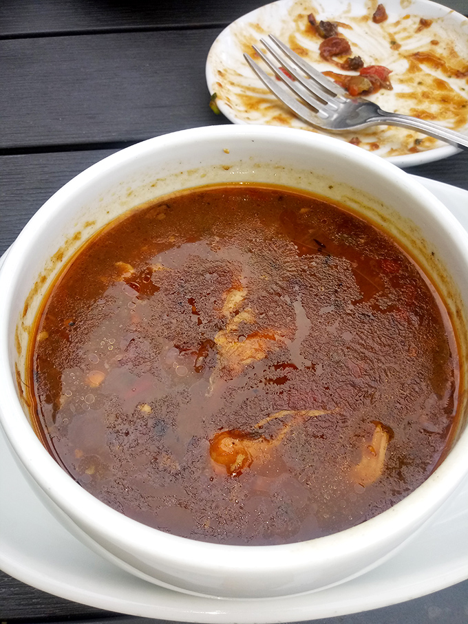 A bowl of onion soup so rich and hearty, it's like a warm hug from your favorite aunt who always sneaks you extra dessert.