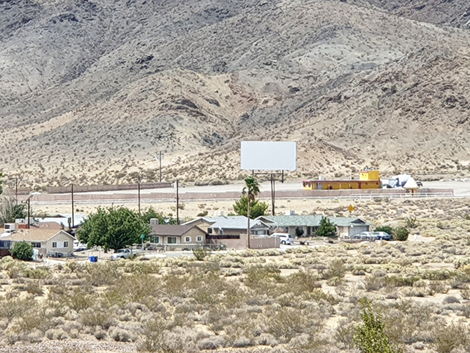 From a distance, the drive-in appears like a mirage in the desert, promising entertainment amid the arid landscape.