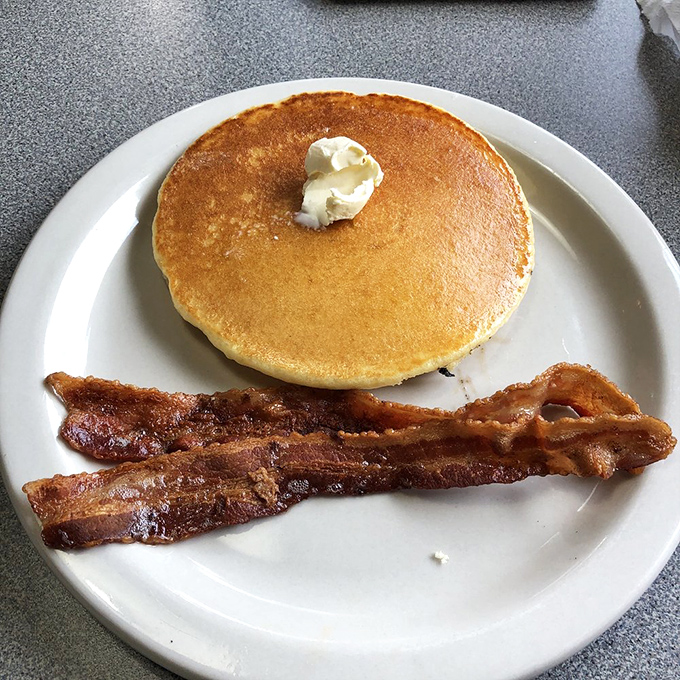 Even breakfast gets the royal treatment here—a perfect golden pancake and crispy bacon provide a momentary respite from chili obsession.