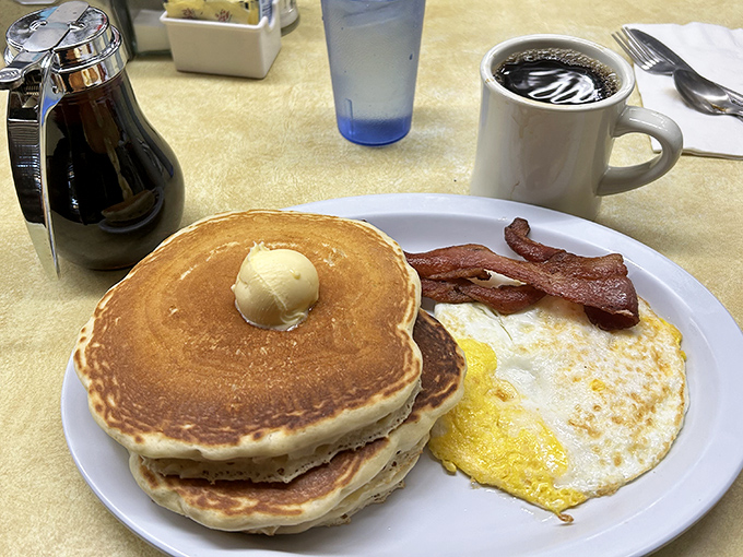 Stack of golden pancakes topped with melting butter—the breakfast equivalent of a perfect vinyl record.