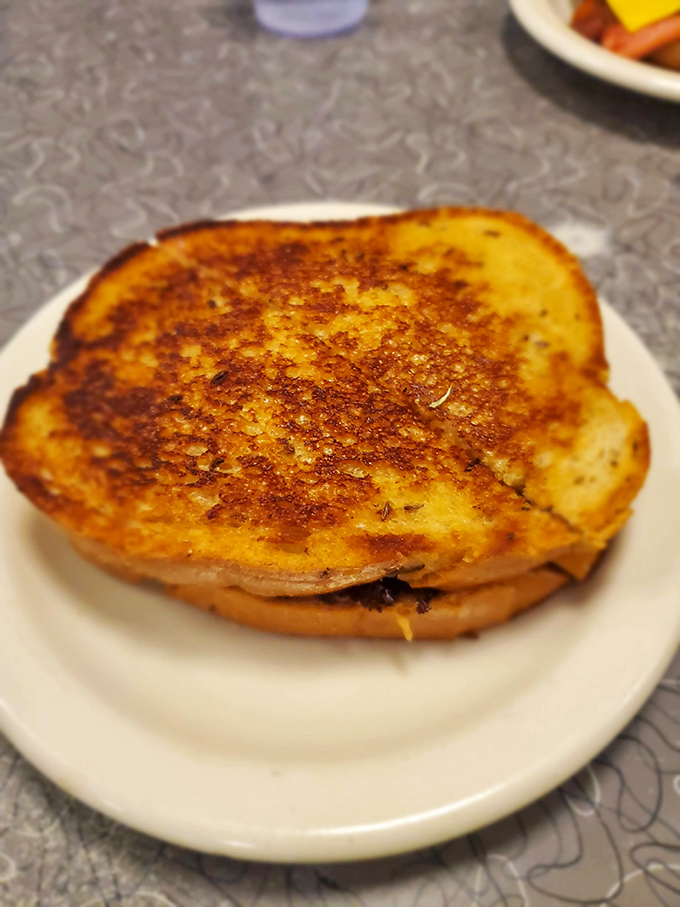 The patty melt: burger's sophisticated cousin. Golden-grilled bread embracing melted cheese and beef—a sandwich that deserves its own fan club.