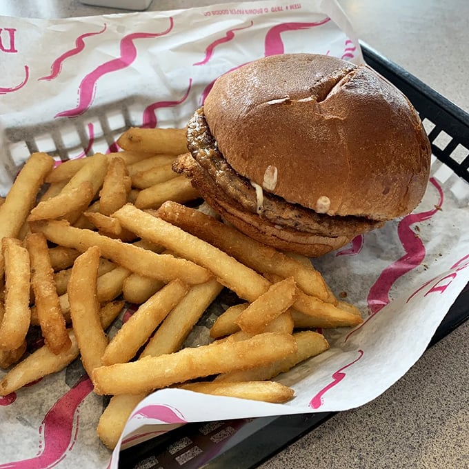 The burger basket arrives like a Norman Rockwell painting you can eat, with fries standing tall as the perfect supporting cast.
