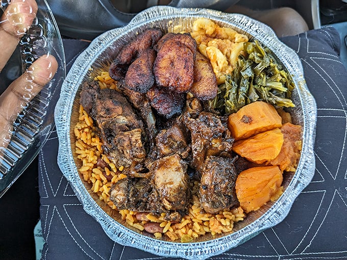 A mountain of jerk chicken atop rice with collard greens and candied yams &ndash; proof that the best things in life come in takeout containers.
