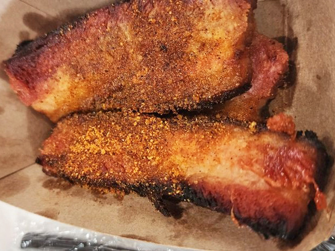 Pork belly with a bark so perfect it deserves its own trophy. The smoke ring tells you this meat has been pampered for hours.