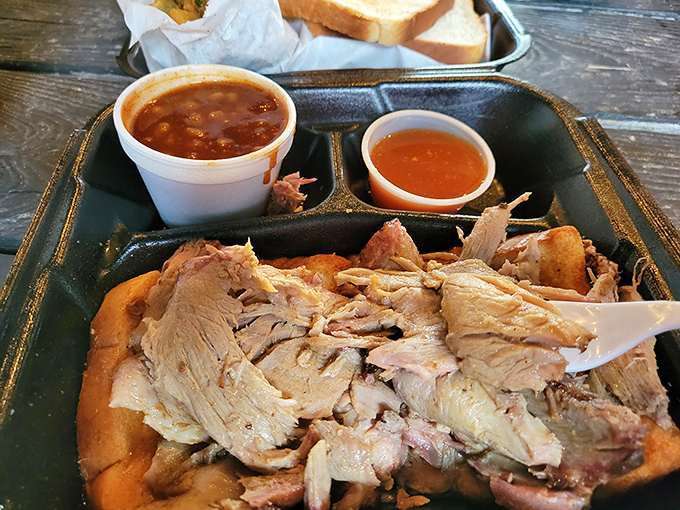 The pork sandwich&mdash;where smoke-kissed meat meets pillowy bread in a marriage that would make any Southerner proud. Simple perfection on a plate.